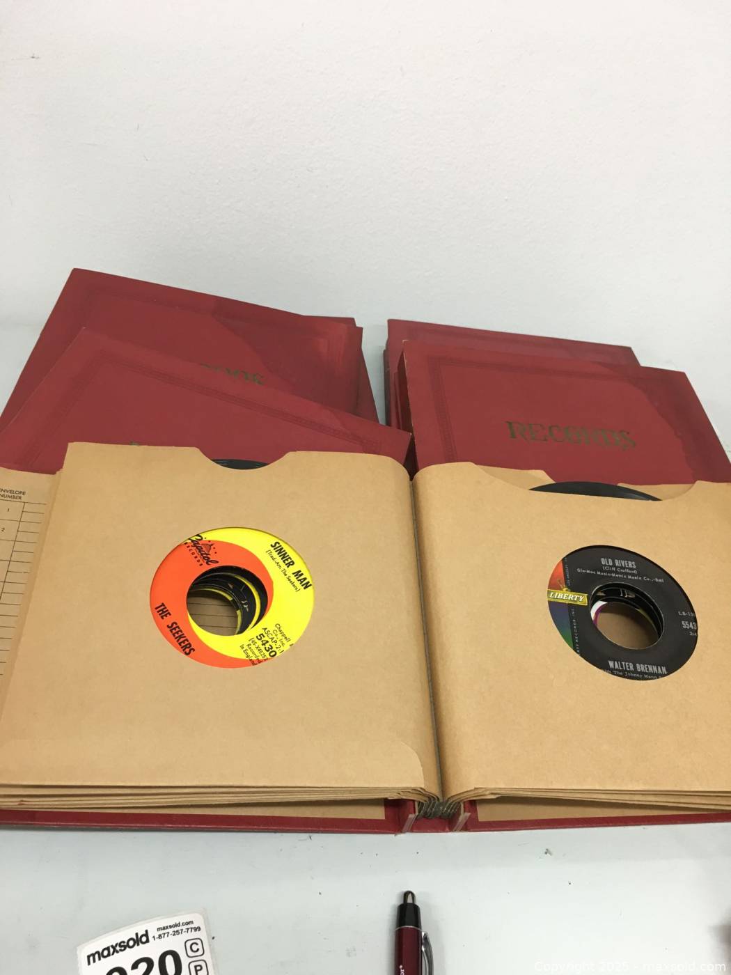 Collection of 7" 45 RPM Vinyl Records with Red Cases. Loosely wrapped ...